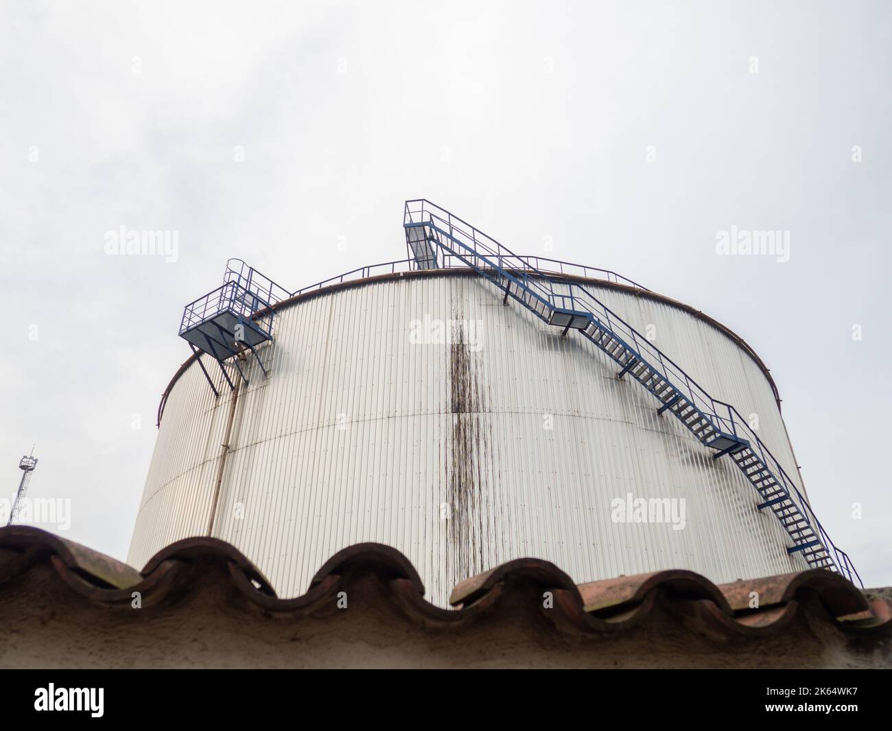 Large fuel tanks. Tanks and ladders of the tank farm. The gloomy ...