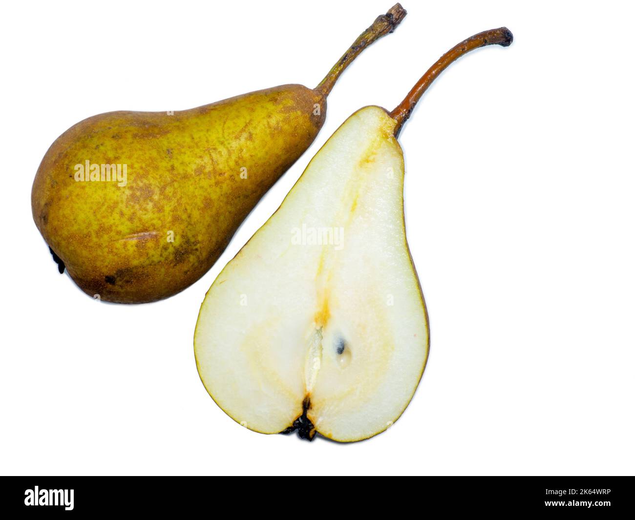 A pear cut in half. The pulp of a juicy fruit. Yellow pear on a white ...