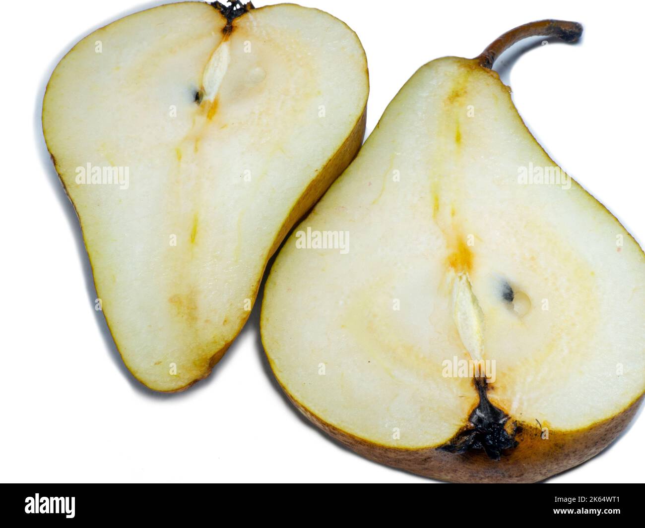 A pear cut in half. The pulp of a juicy fruit. Yellow pear on a white ...