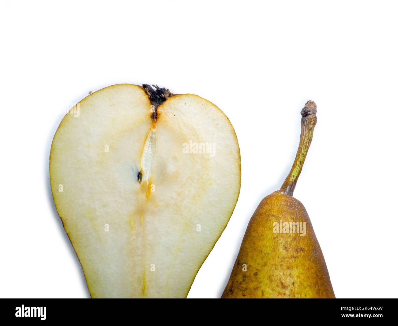 A pear cut in half. The pulp of a juicy fruit. Yellow pear on a white ...