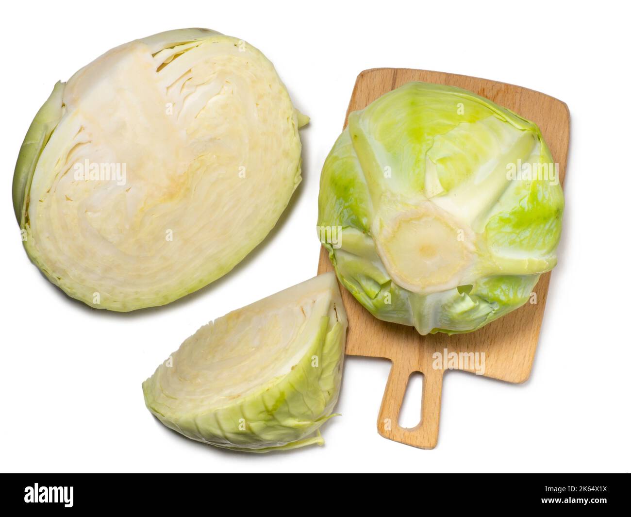 Pieces of white cabbage on a kitchen board on a white background ...