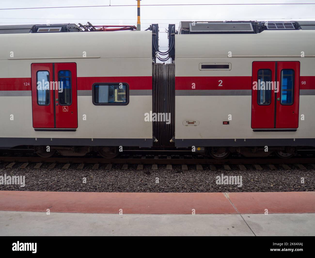 Passenger train at the station. Passenger transportation. At the pier ...