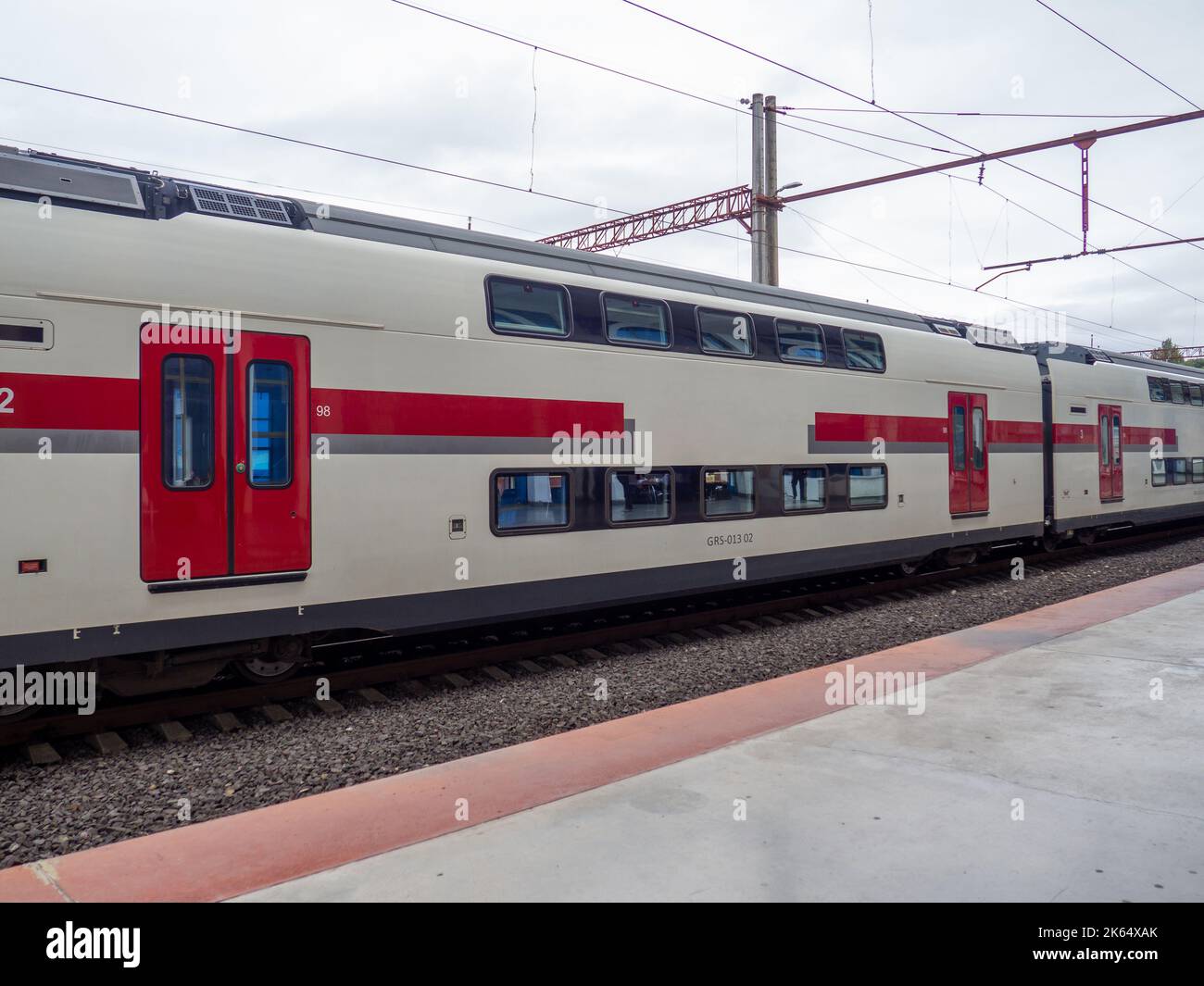 Passenger train at the station. Passenger transportation. At the pier ...