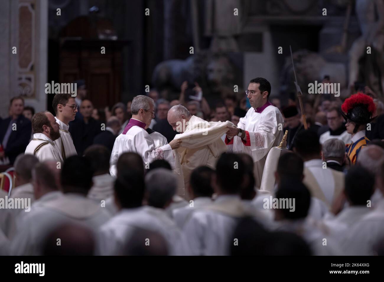 Vatican City, Vatican. 11th Oct, 2022. Pope Francis is helped to wear ...