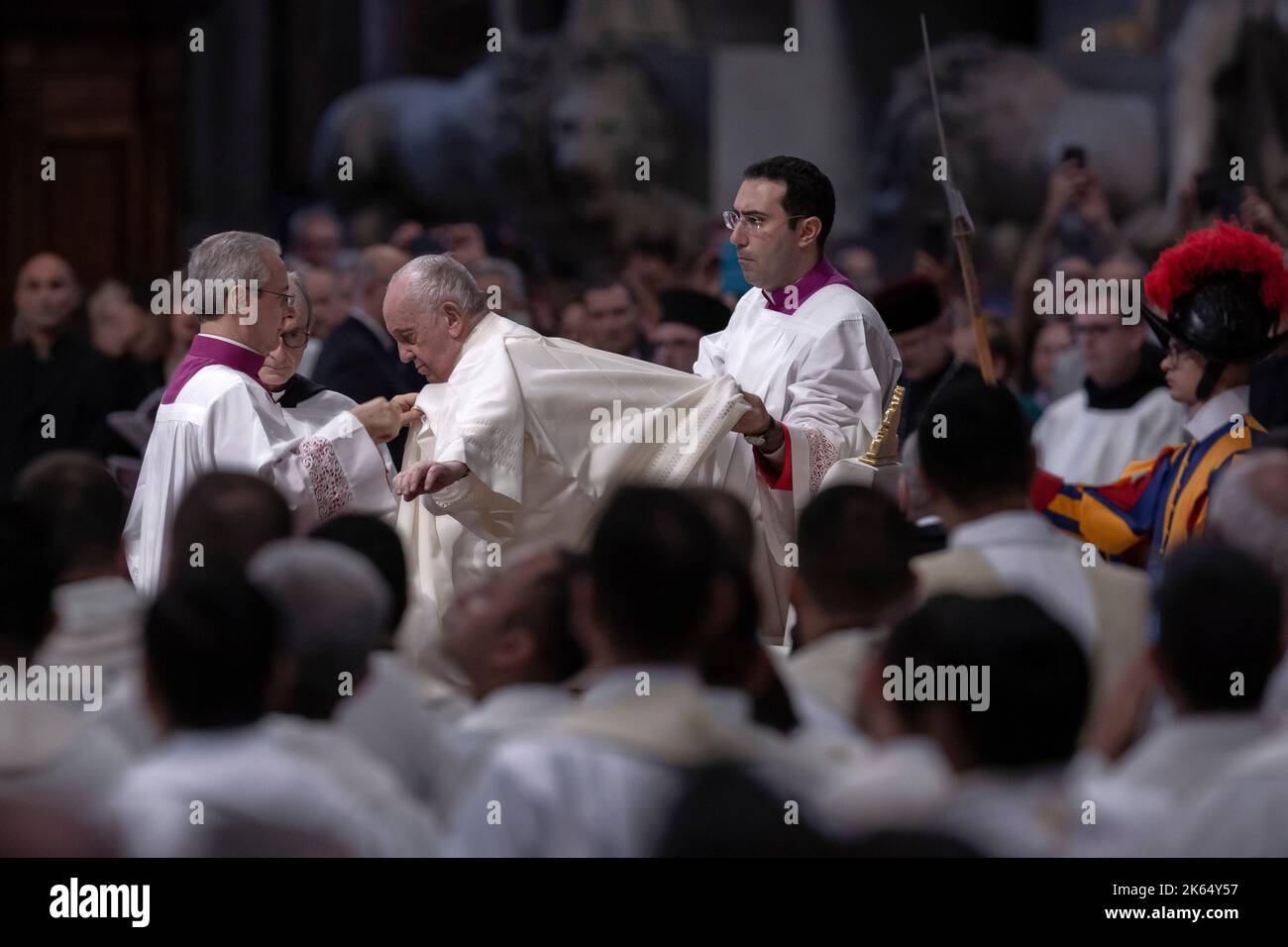 Vatican City, Vatican. 11th Oct, 2022. Pope Francis is helped to wear ...