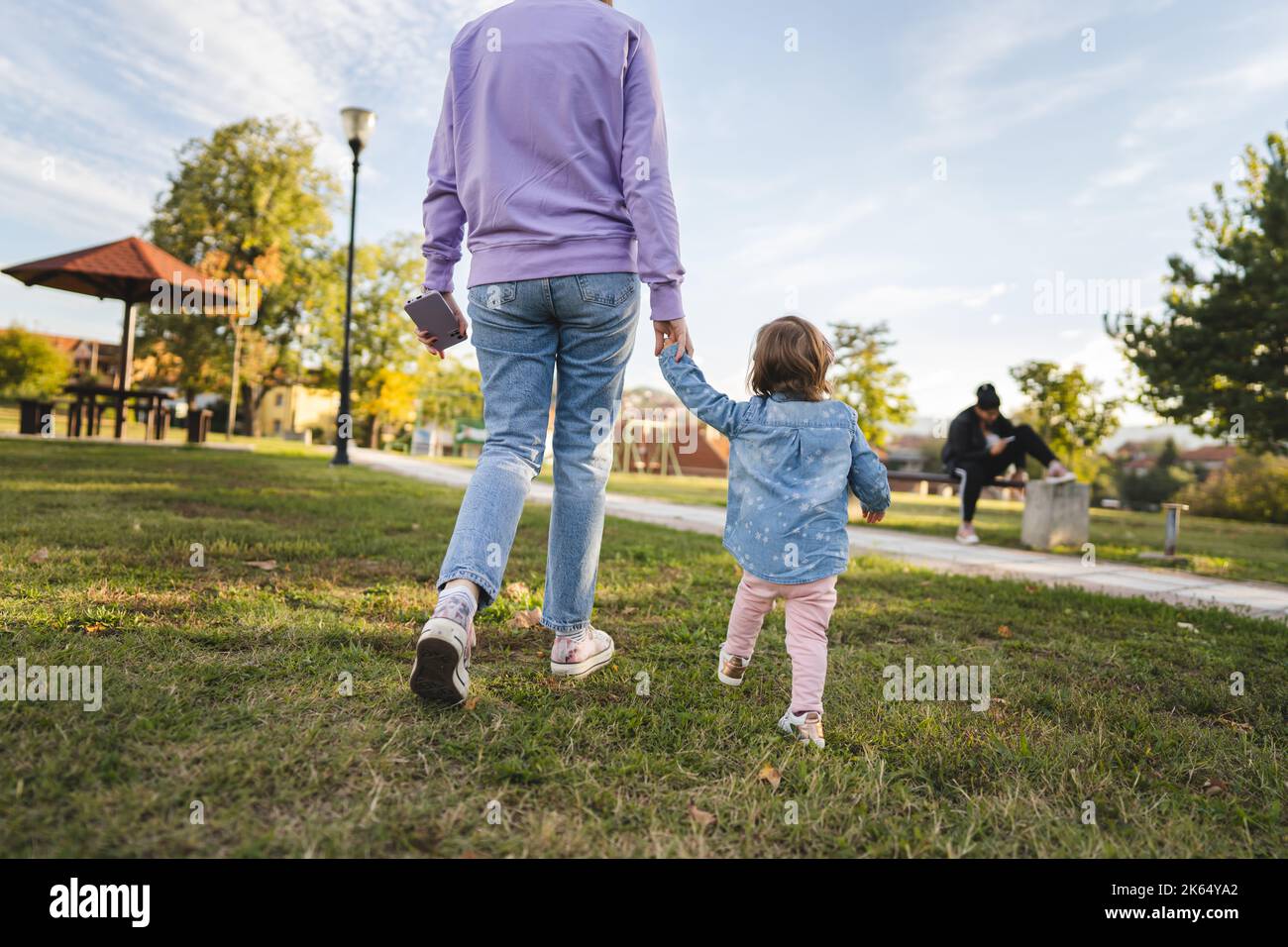 back view of unknown mother and child woman and daughter female girl ...