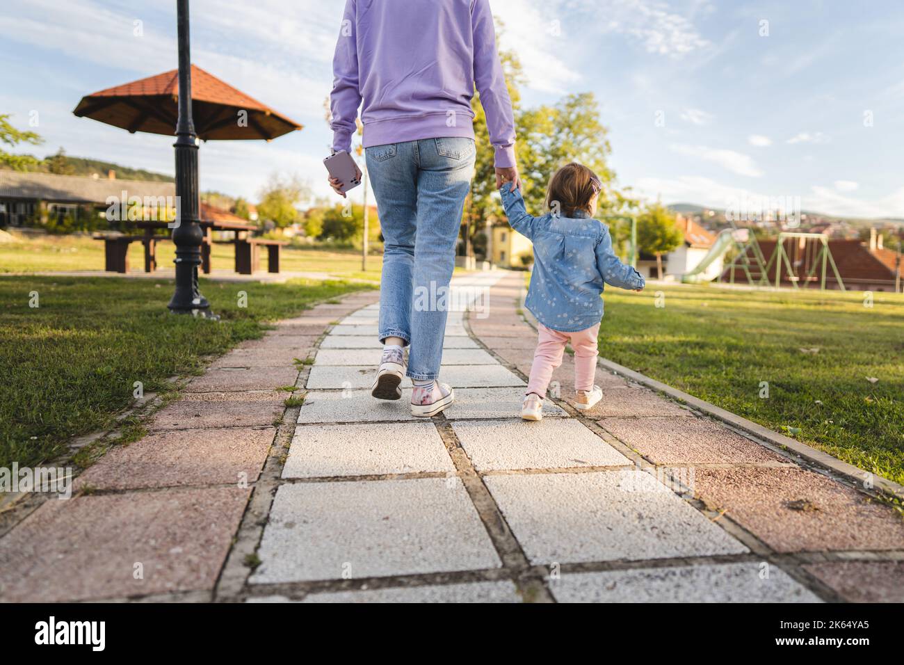 back view of unknown mother and child woman and daughter female girl ...