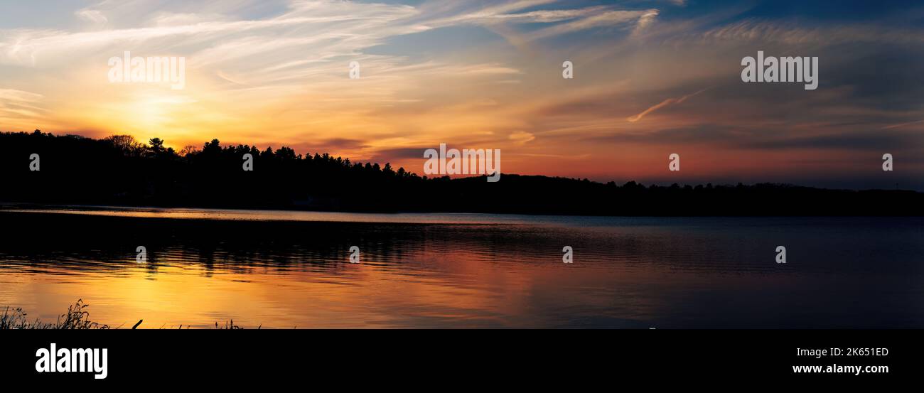 Soft and bright sunset on a pond in eastern Massachusetts. Yellow ...