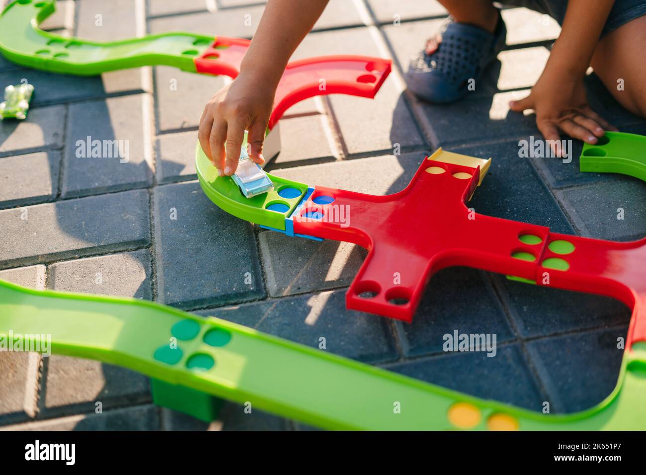 Boy playing in the yard of the house with multicoloured and attractive ...