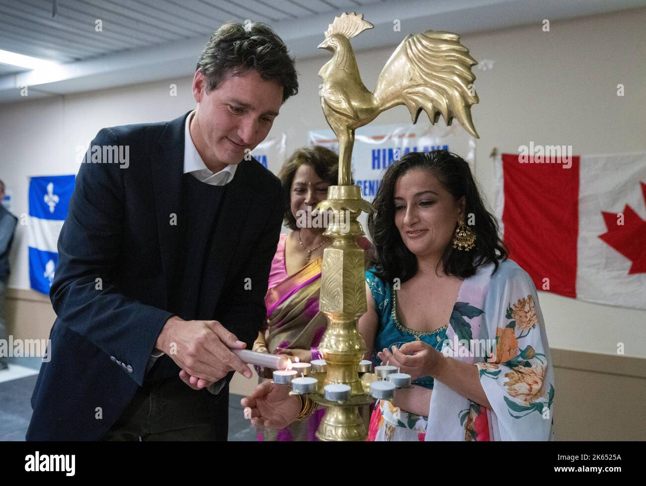 Prime Minister Justin Trudeau lights a candle during 25th anniversary ...