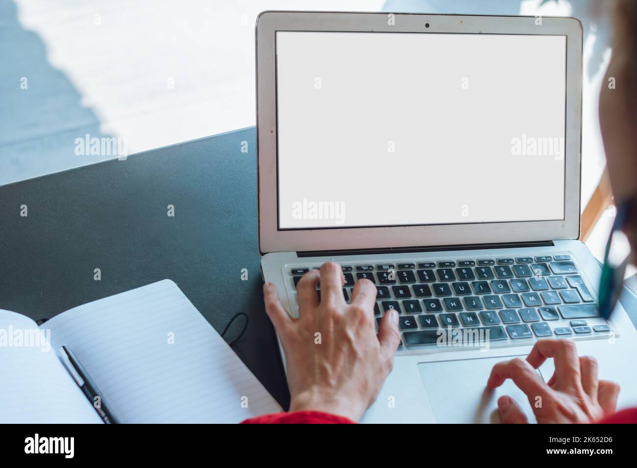 rear view close up of young caucasian woman working watching laptop ...