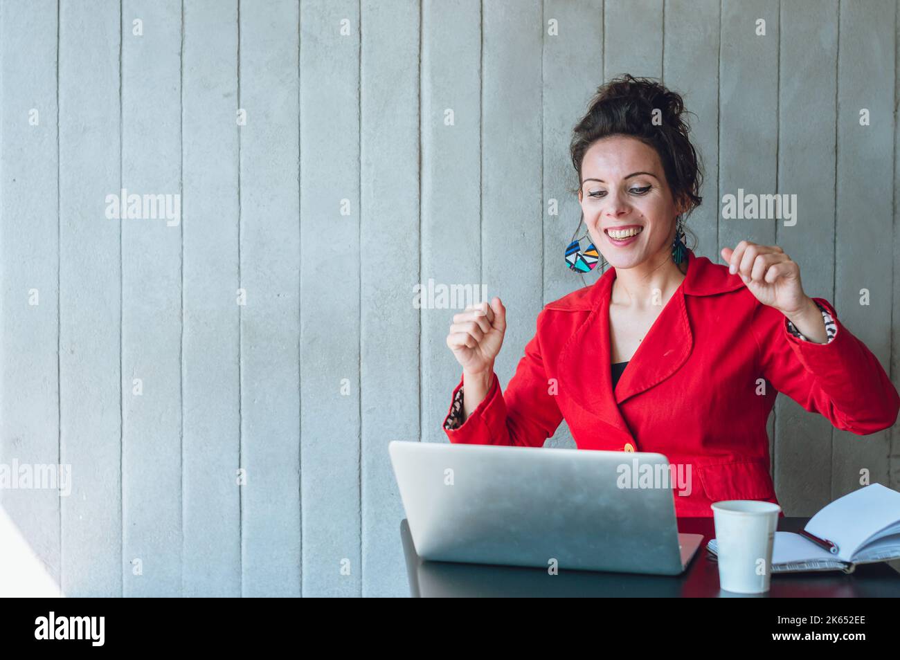 Caucasian young woman sitting with her laptop in a coffee shop, she is ...