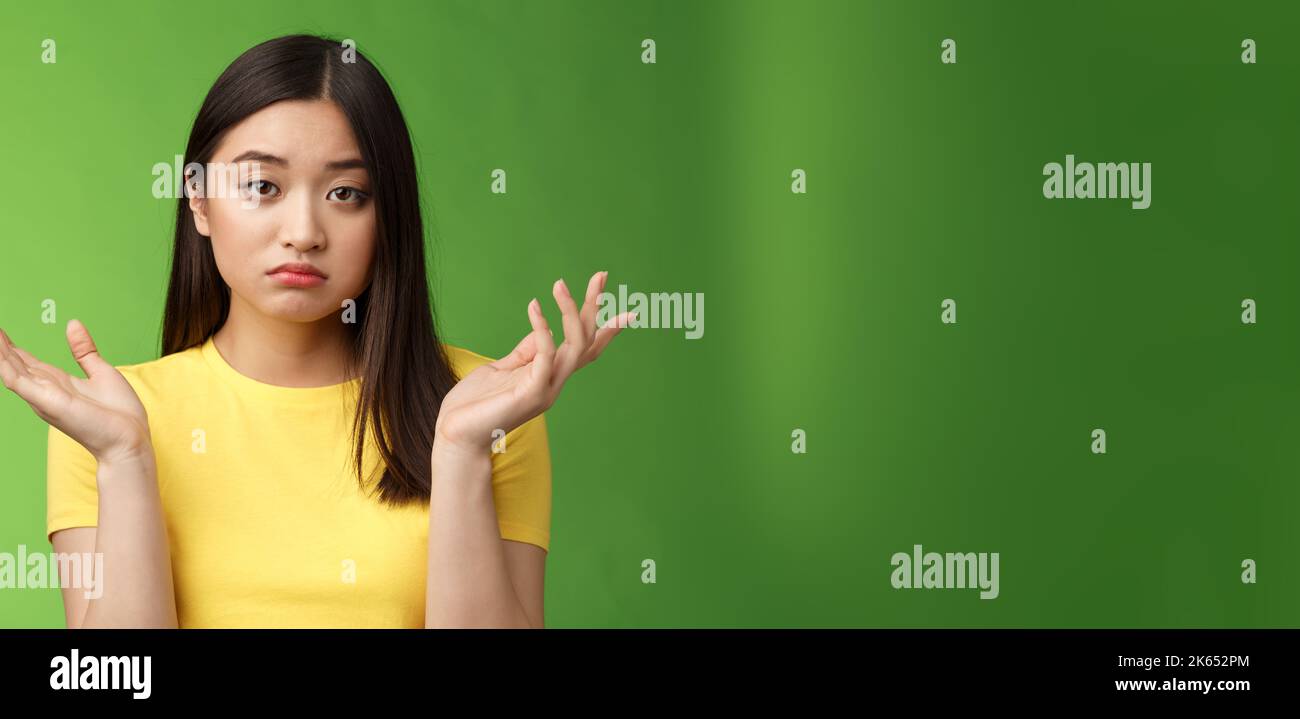 Close-up confused unemotive brunette woman spread hands sideways full ...