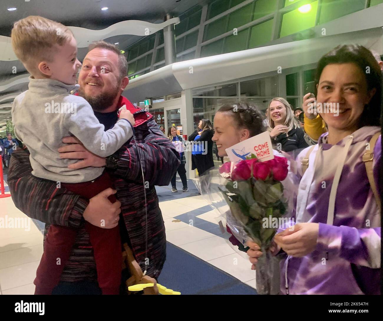 Sergii Plakhtii holds his young son Makar as his wife Yuliia and ...