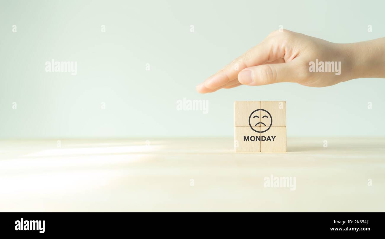 Avoid feeling down on blue Monday concept. Protection wooden cubes with ...