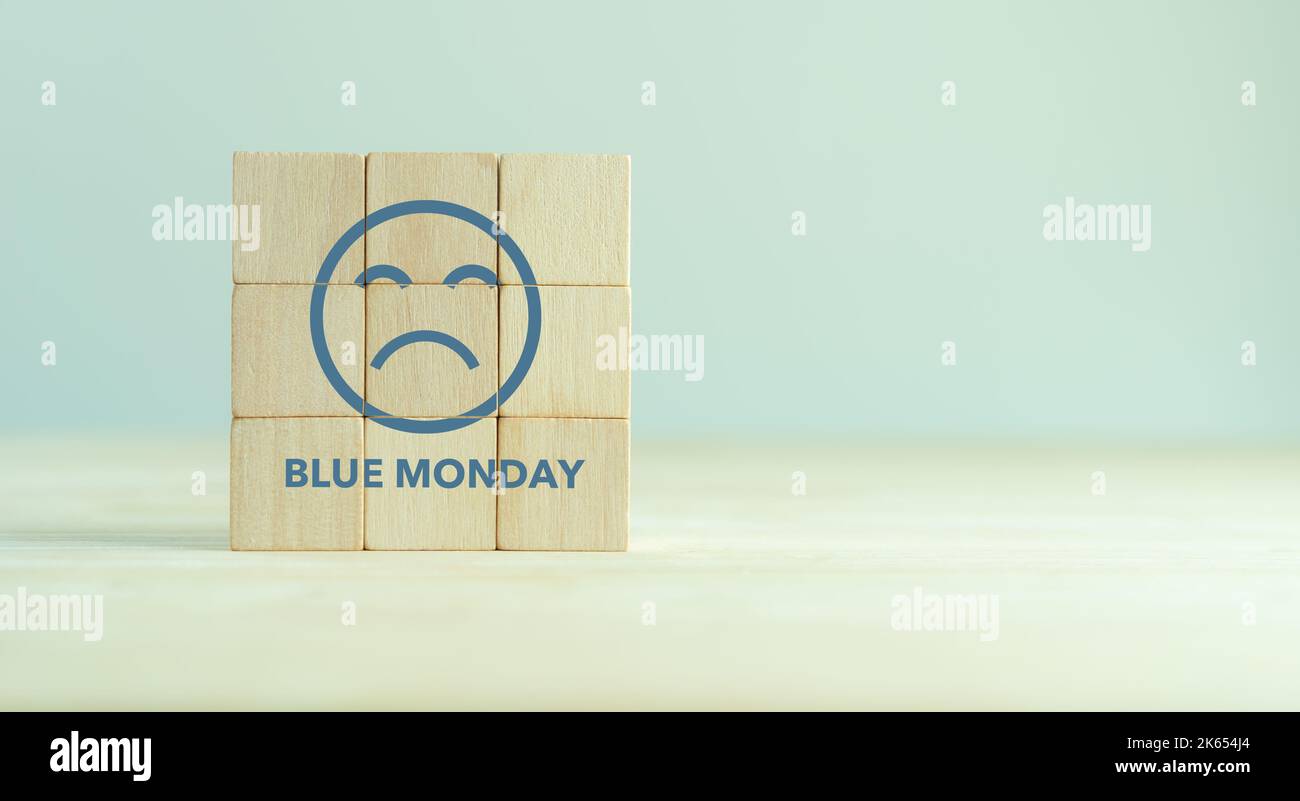 Blue monday concept. Wooden cubes with a sad face drawn. Monday blues ...