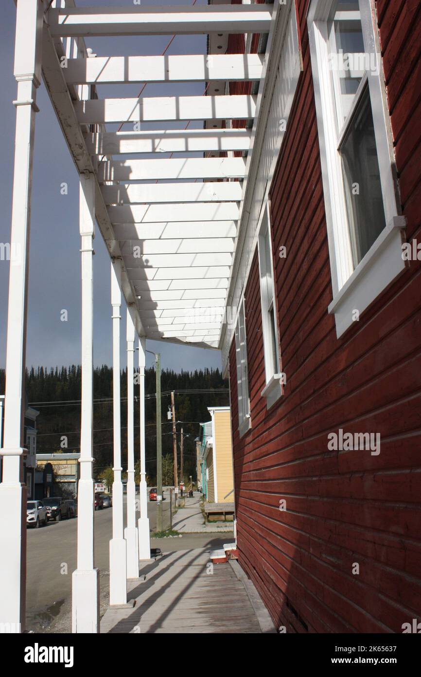 Wooden poles and sidewalk by the Downtown Hotel in Dawson City, Yukon ...