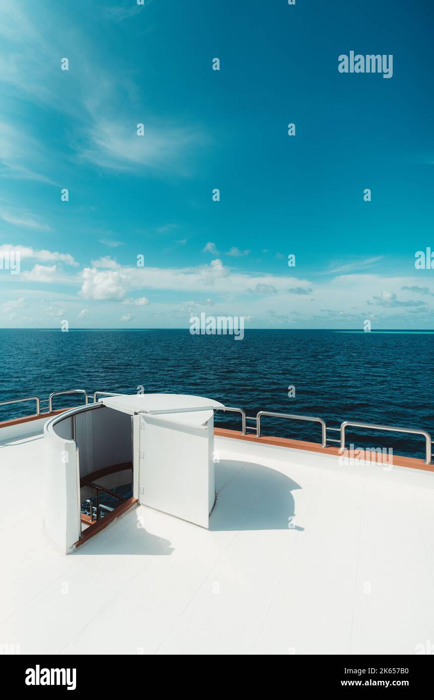 A vertical wide-angle shot of a bright diving safari yacht top deck ...