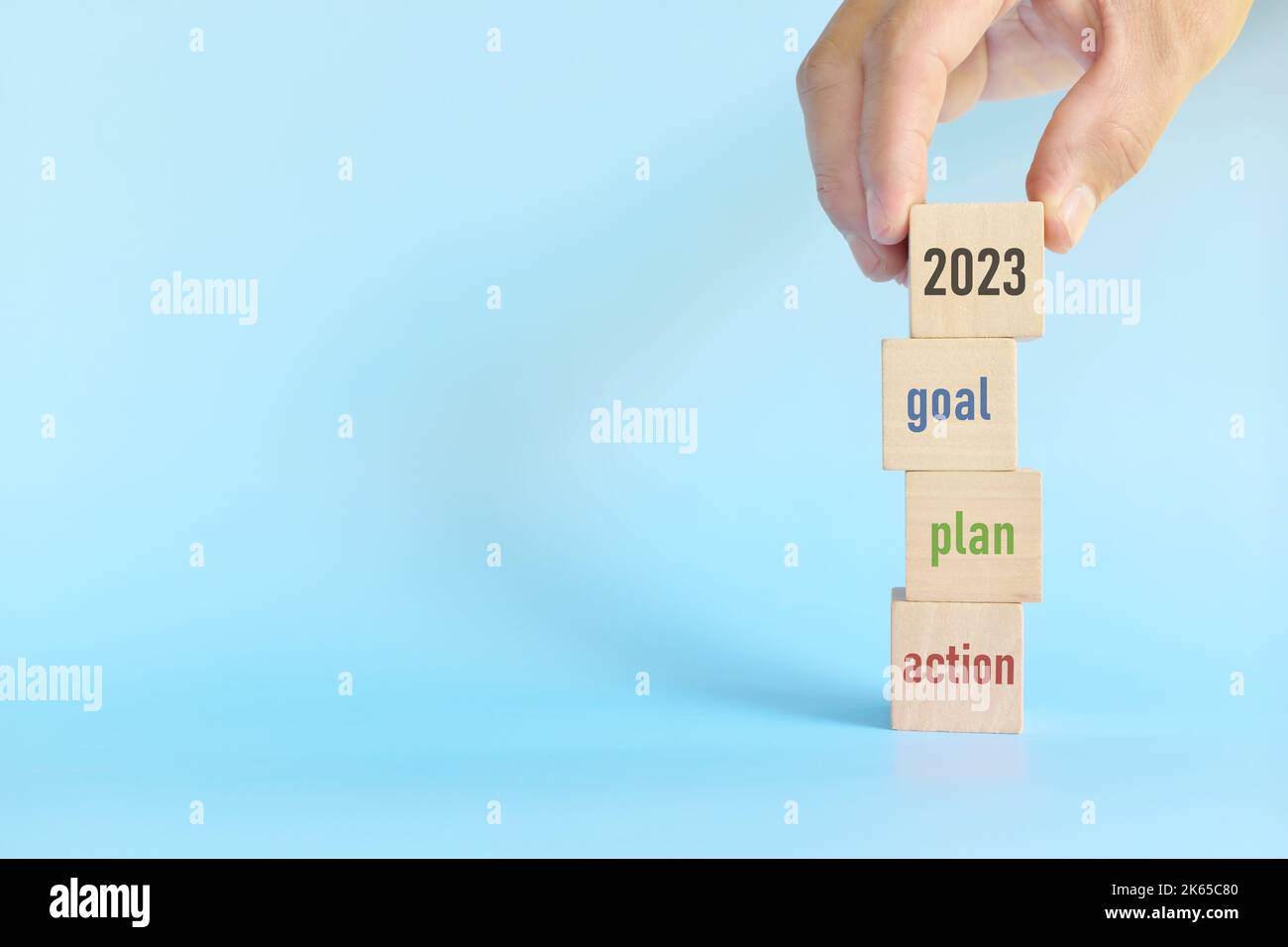 Start New Year 2023 business target goal concept. Human hand stacking ...