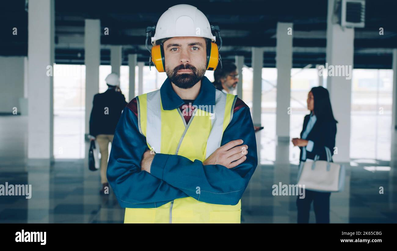 Portrait of male maintenance specialist in uniform standing inside new ...