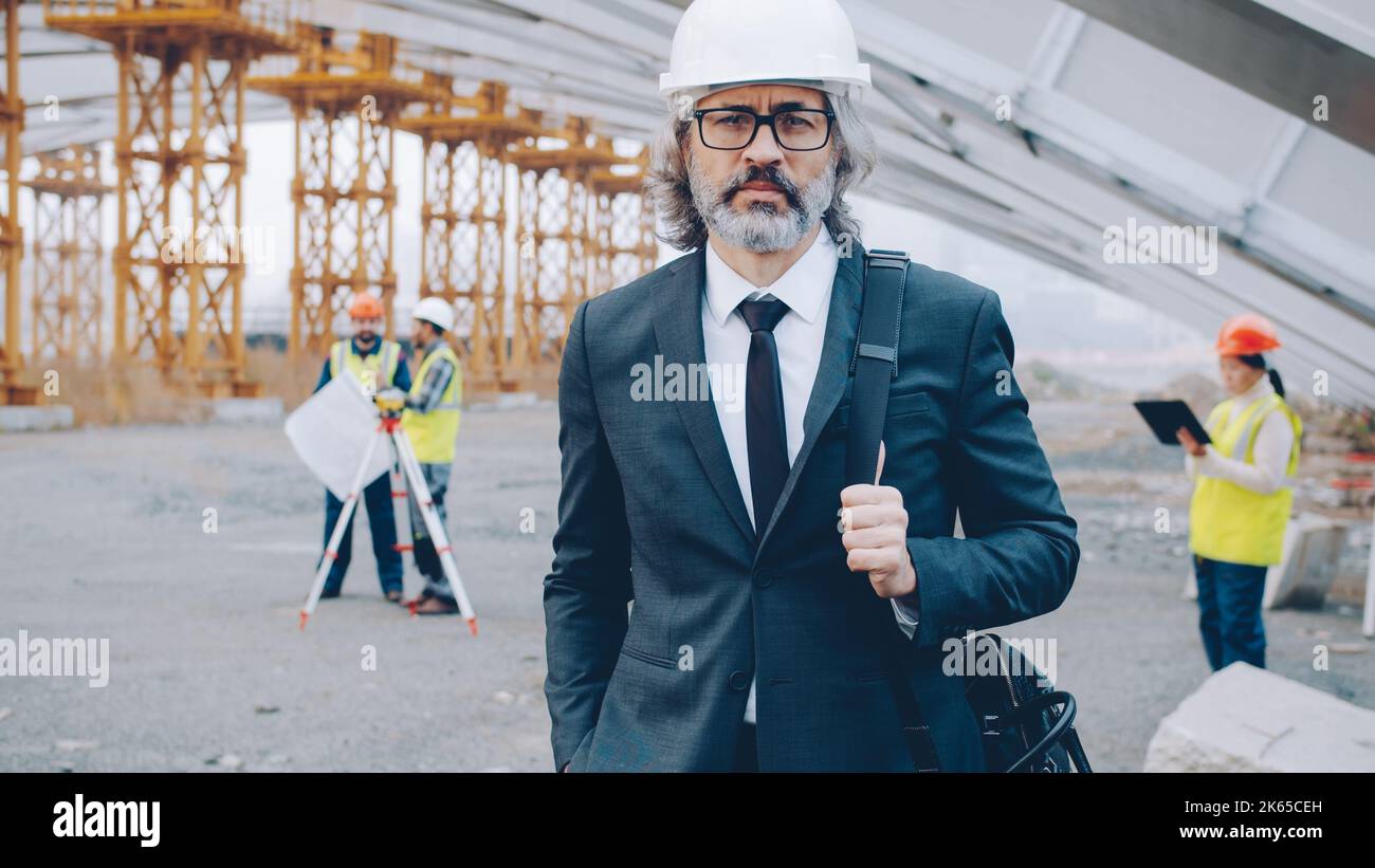 portrait of construction project manager standing outdoors wearing ...