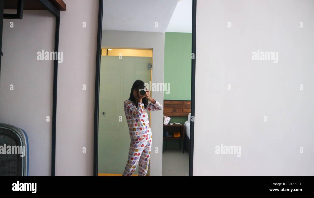 Manado - Indonesia, October 8, 2022, a beautiful girl takes a picture ...