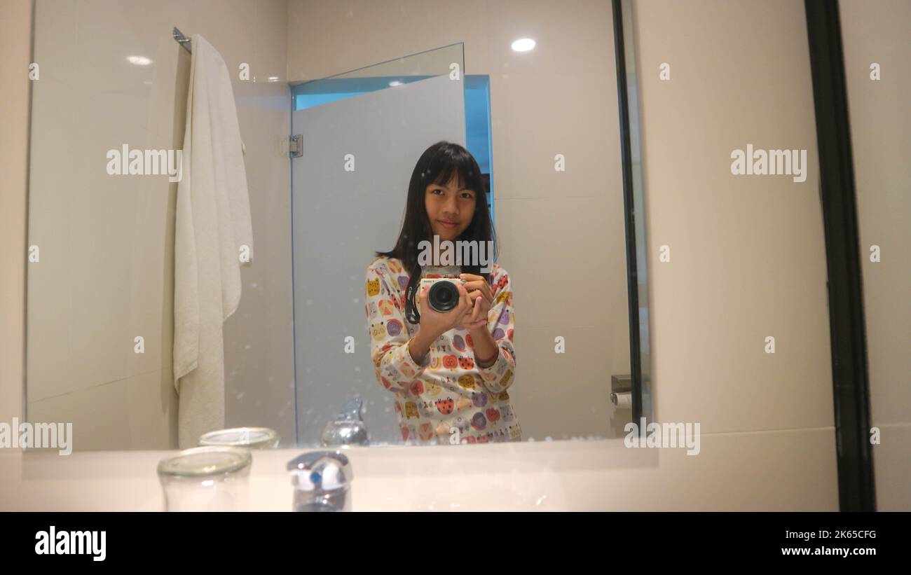Manado - Indonesia, October 8, 2022, a beautiful girl takes a picture ...