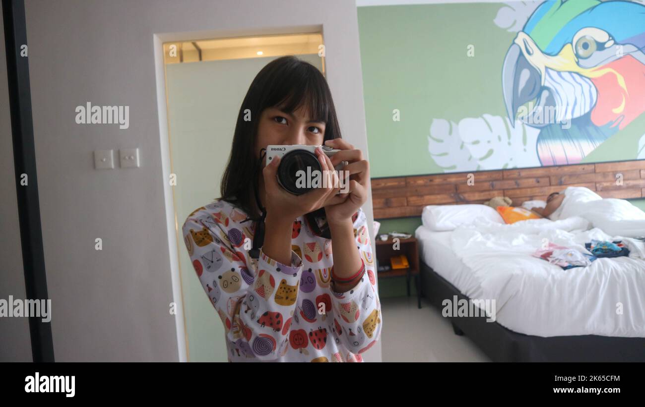 Manado - Indonesia, October 8, 2022, a beautiful girl takes a picture ...