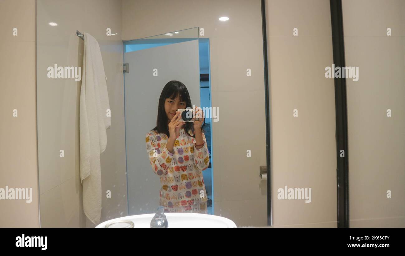 Manado - Indonesia, October 8, 2022, a beautiful girl takes a picture ...