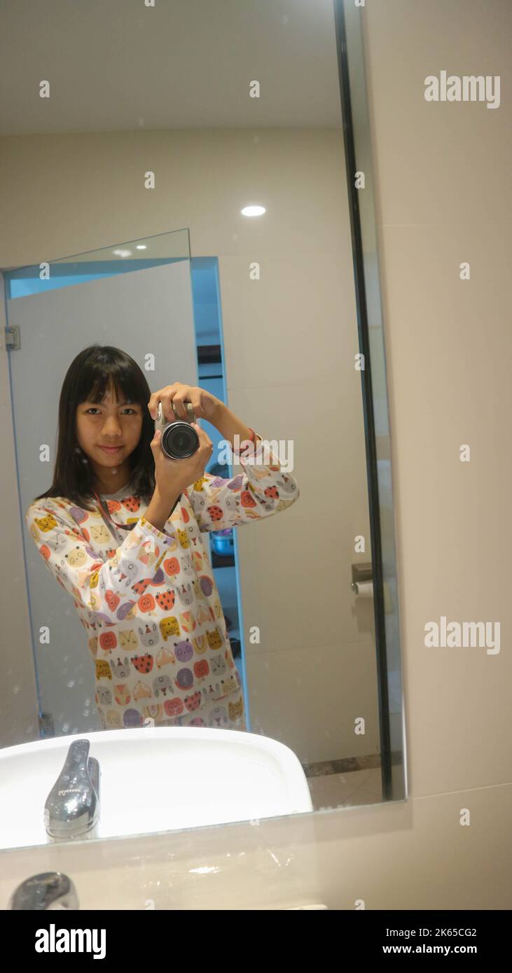 Manado - Indonesia, October 8, 2022, a beautiful girl takes a picture ...