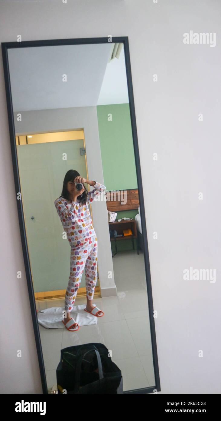Manado - Indonesia, October 8, 2022, a beautiful girl takes a picture ...