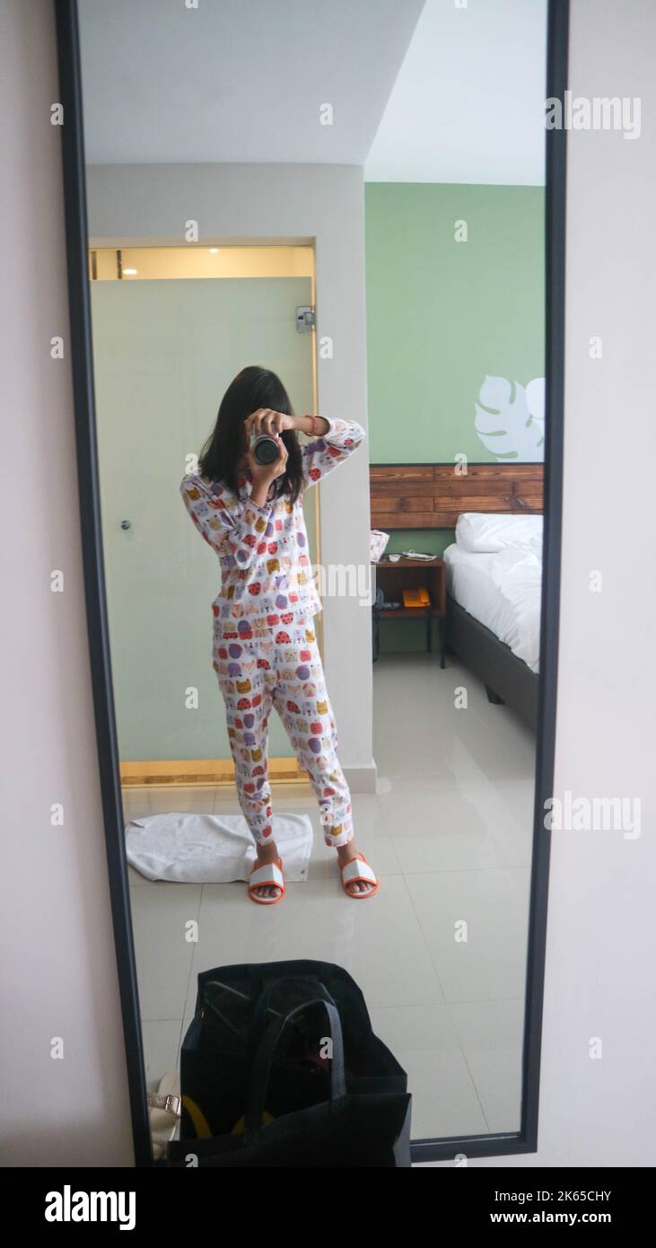 Manado - Indonesia, October 8, 2022, a beautiful girl takes a picture ...