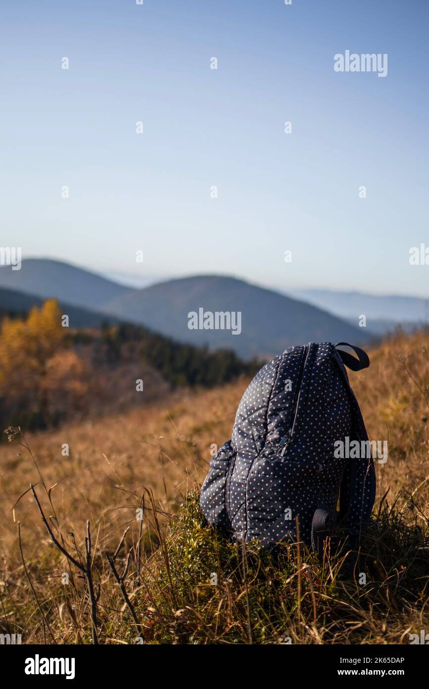 Tourist backpack on ground in front of mountains landscape Stock Photo ...