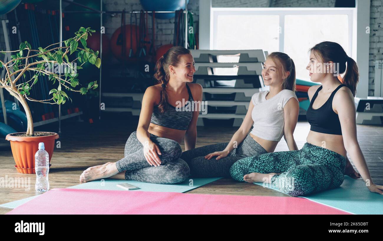 Cheerful pretty girls are socialising in wellness center sitting on ...