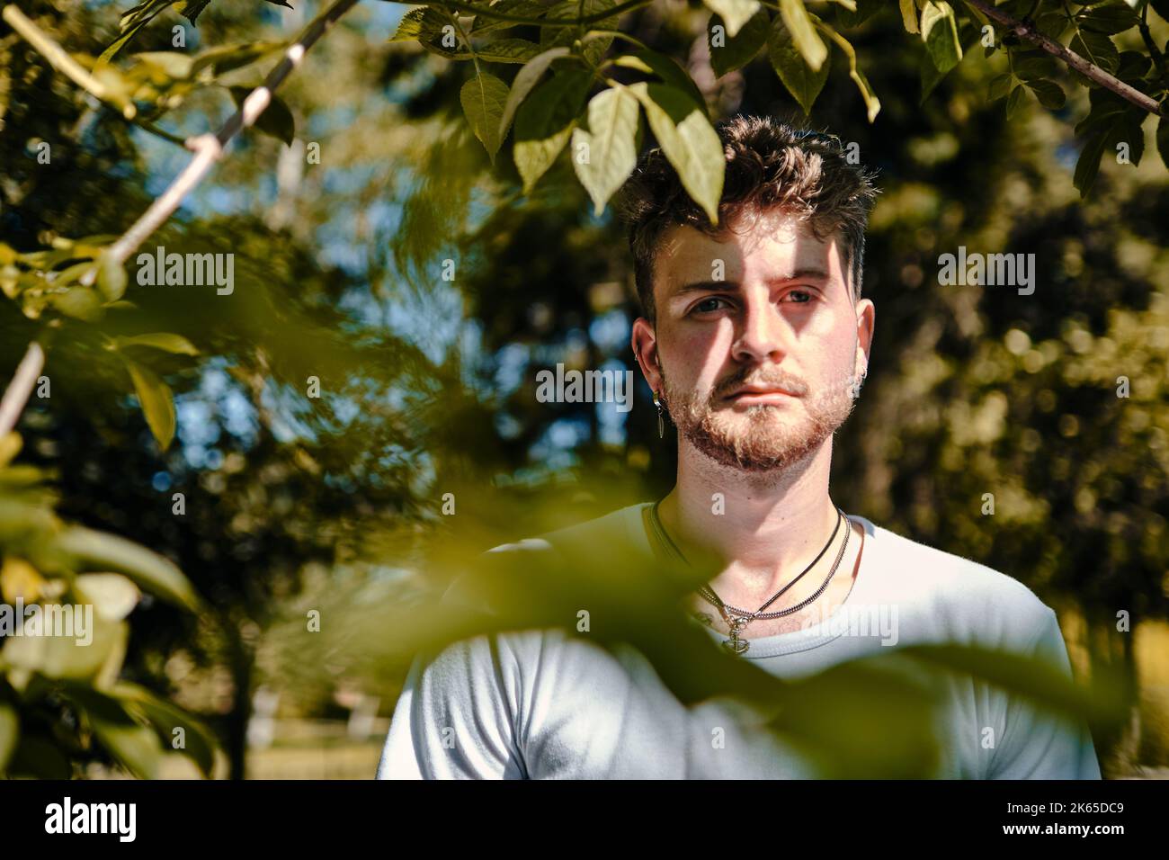 A portrait of a fashionable and mysterious blond guy with blue eyes ...