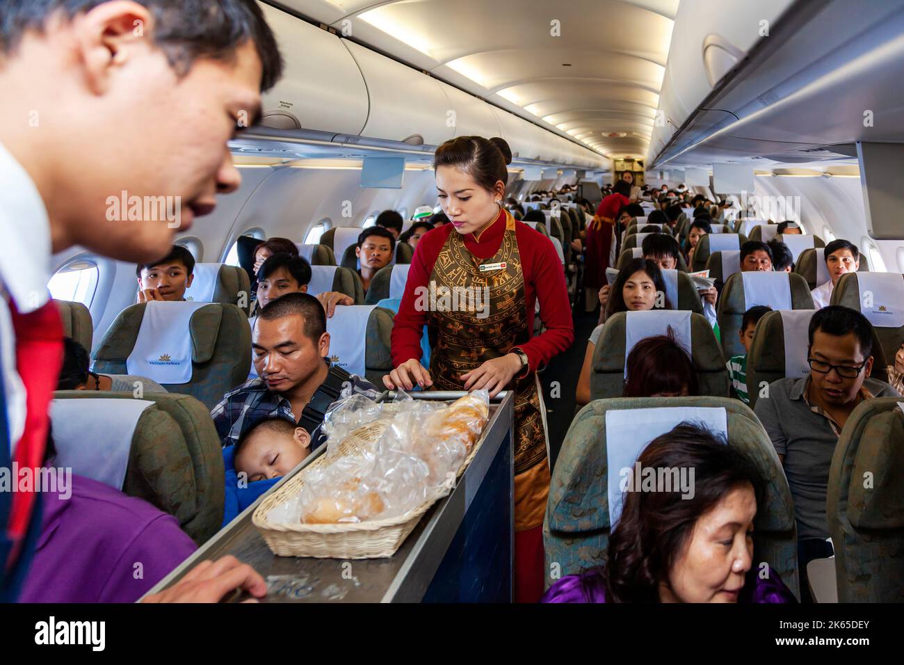 Flight crew and passengers on board Vietnam Airlines flight from Hanoi ...