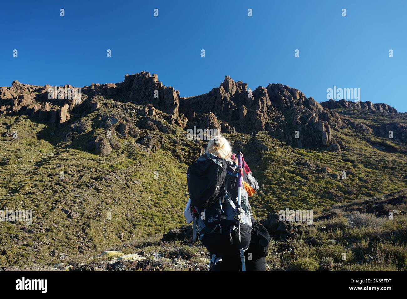 Single blonde woman walking at Tongariro National park in New Zealand ...