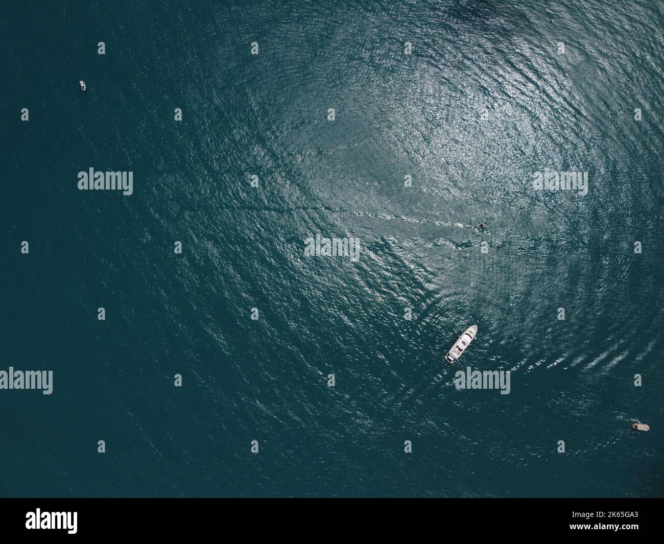 Aerial yacht on calm sea. Luxury cruise trip. View from above of white ...