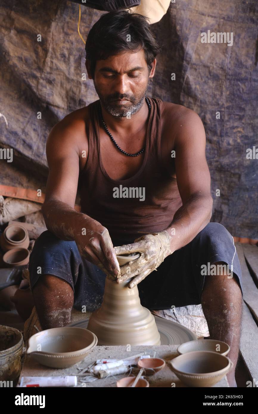 9 October 2022, Pune, India, Indian potter making Diya (oil lamps) or ...