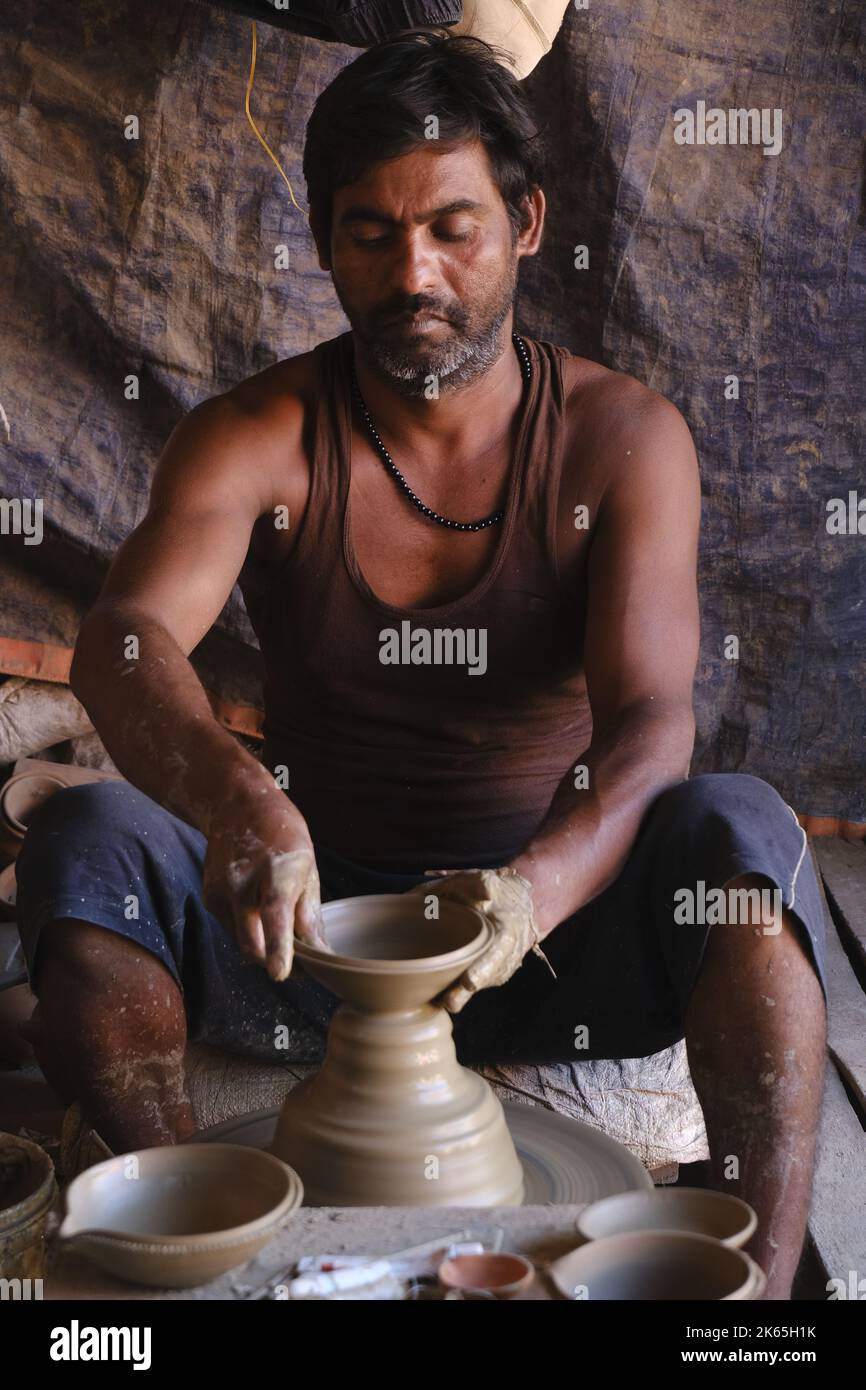 9 October 2022, Pune, India, Indian potter making Diya (oil lamps) or ...