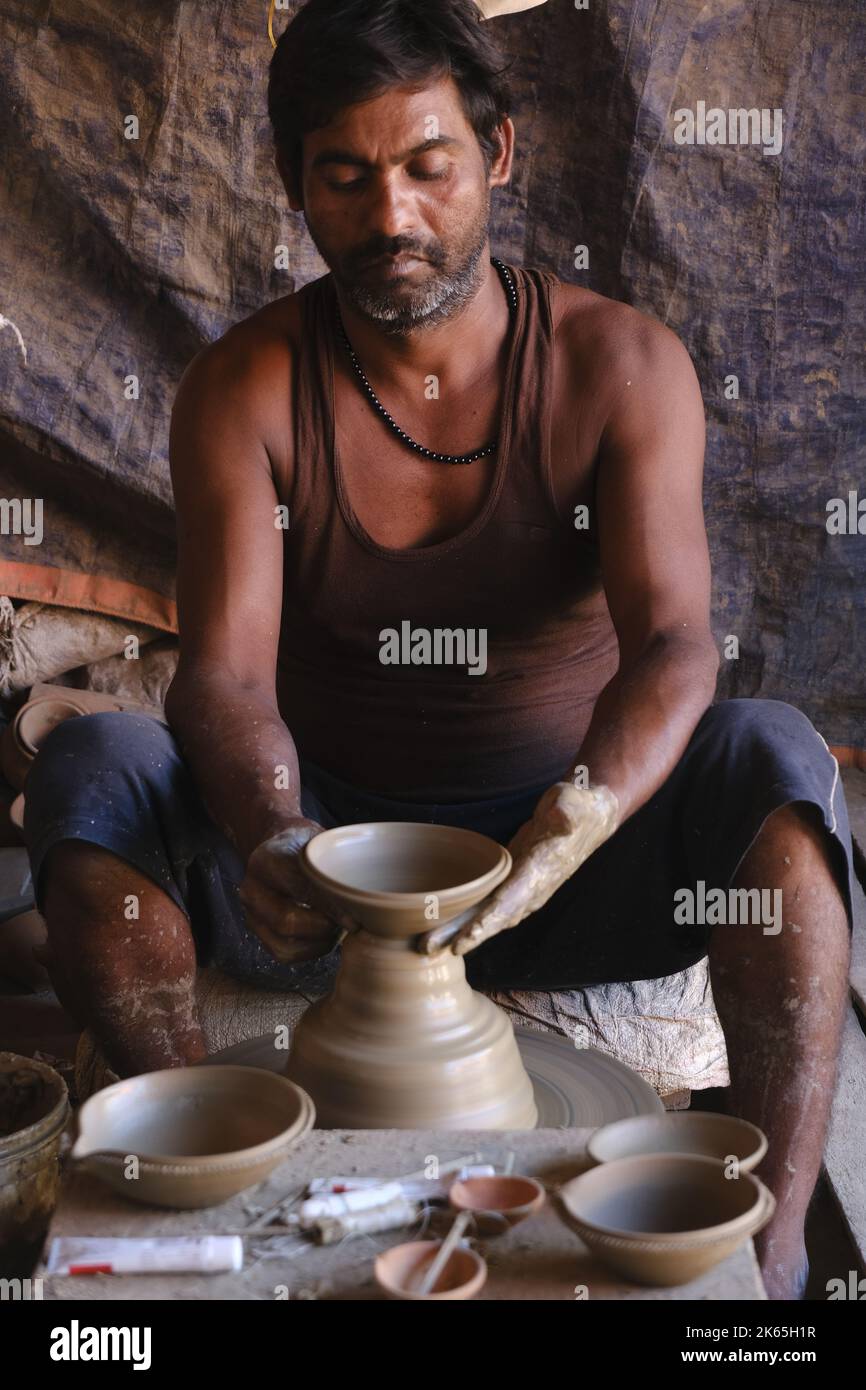 9 October 2022, Pune, India, Indian potter making Diya (oil lamps) or ...