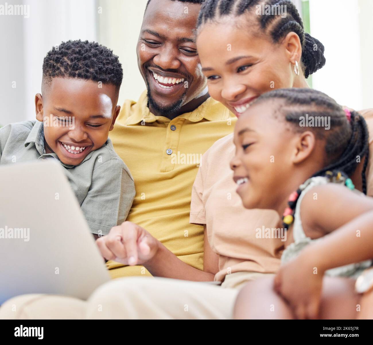 Its family movie day. a young family sitting on the sofa together at ...