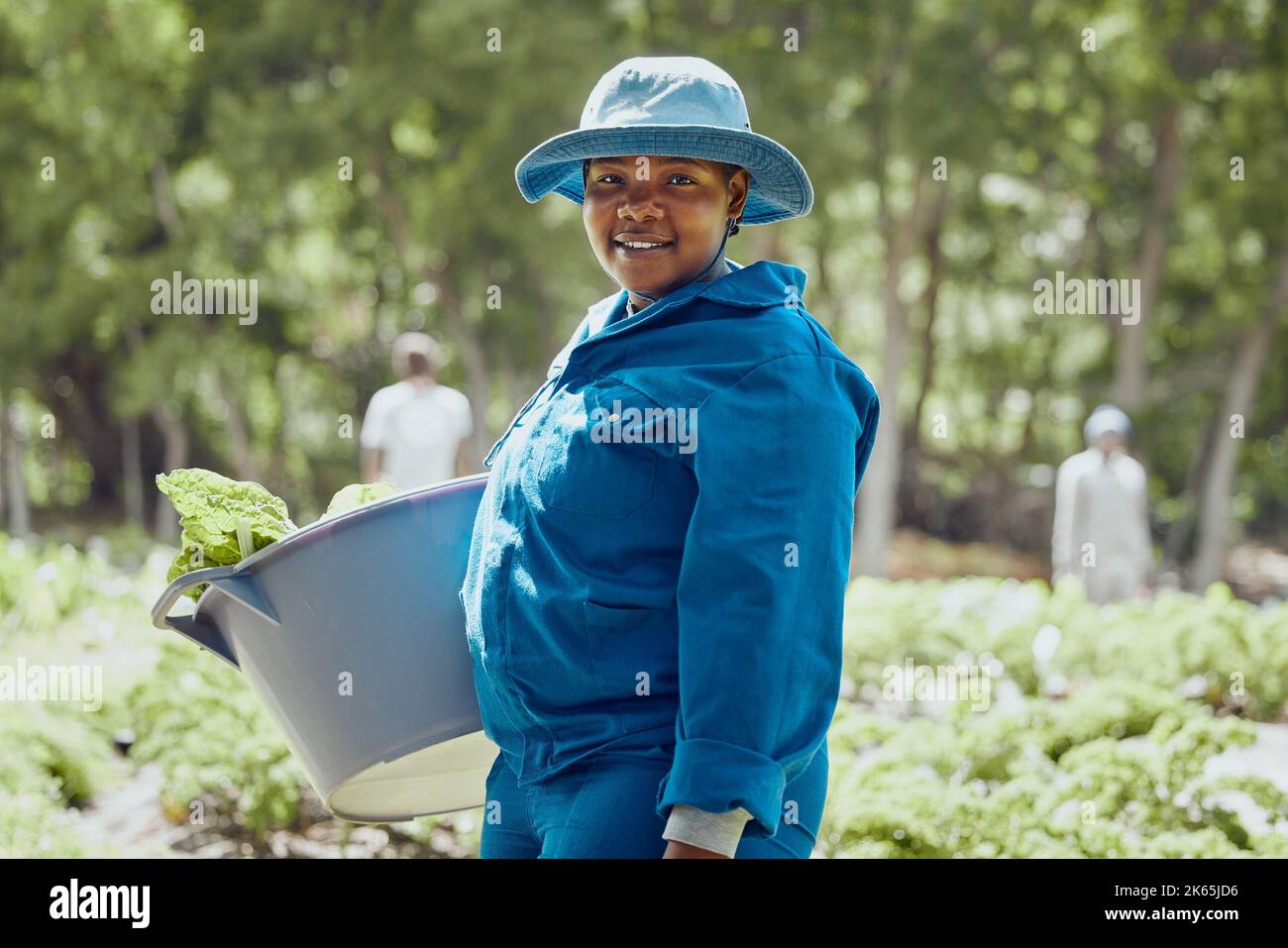 Time to fill up another bucket. an attractive young farmer standing ...