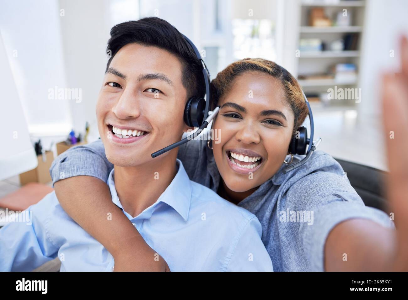 Portrait of call center colleagues taking a selfie showing diversity at ...