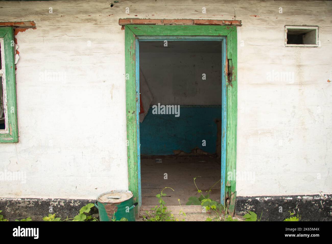 old abandoned one-story building dark without windows and doors, destroyed building in Ukraine ...