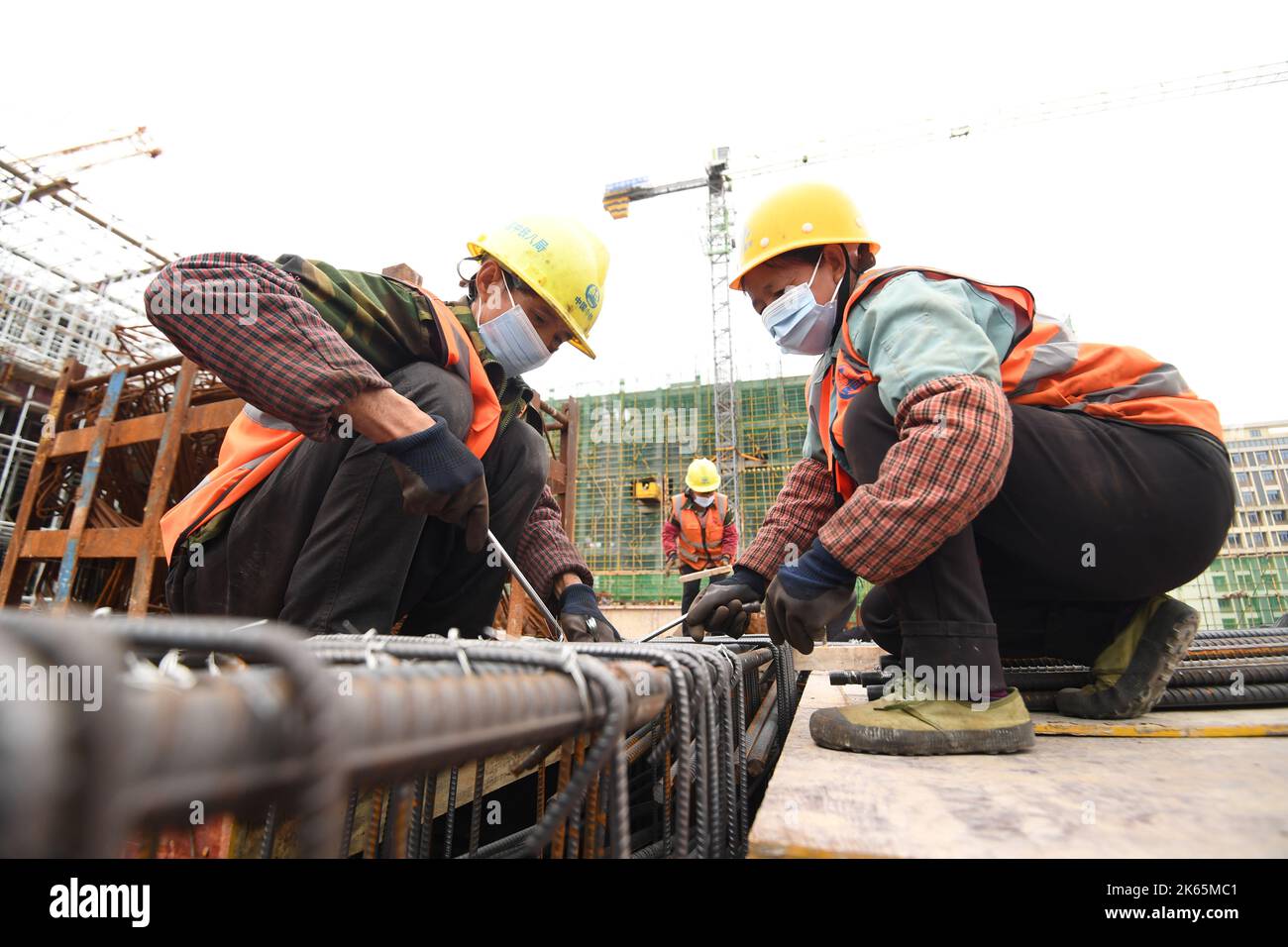 GUIYANG, CHINA - OCTOBER 12, 2022 - A construction worker straps steel ...