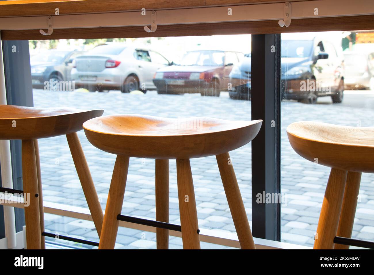wooden chairs near the bar near the window showcase, bar interior ...