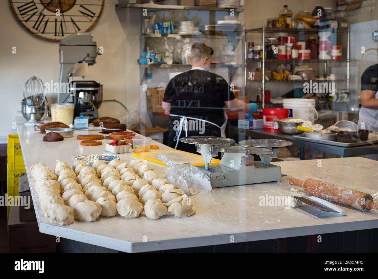 View through the window of a woman working in an artisan bakery ...