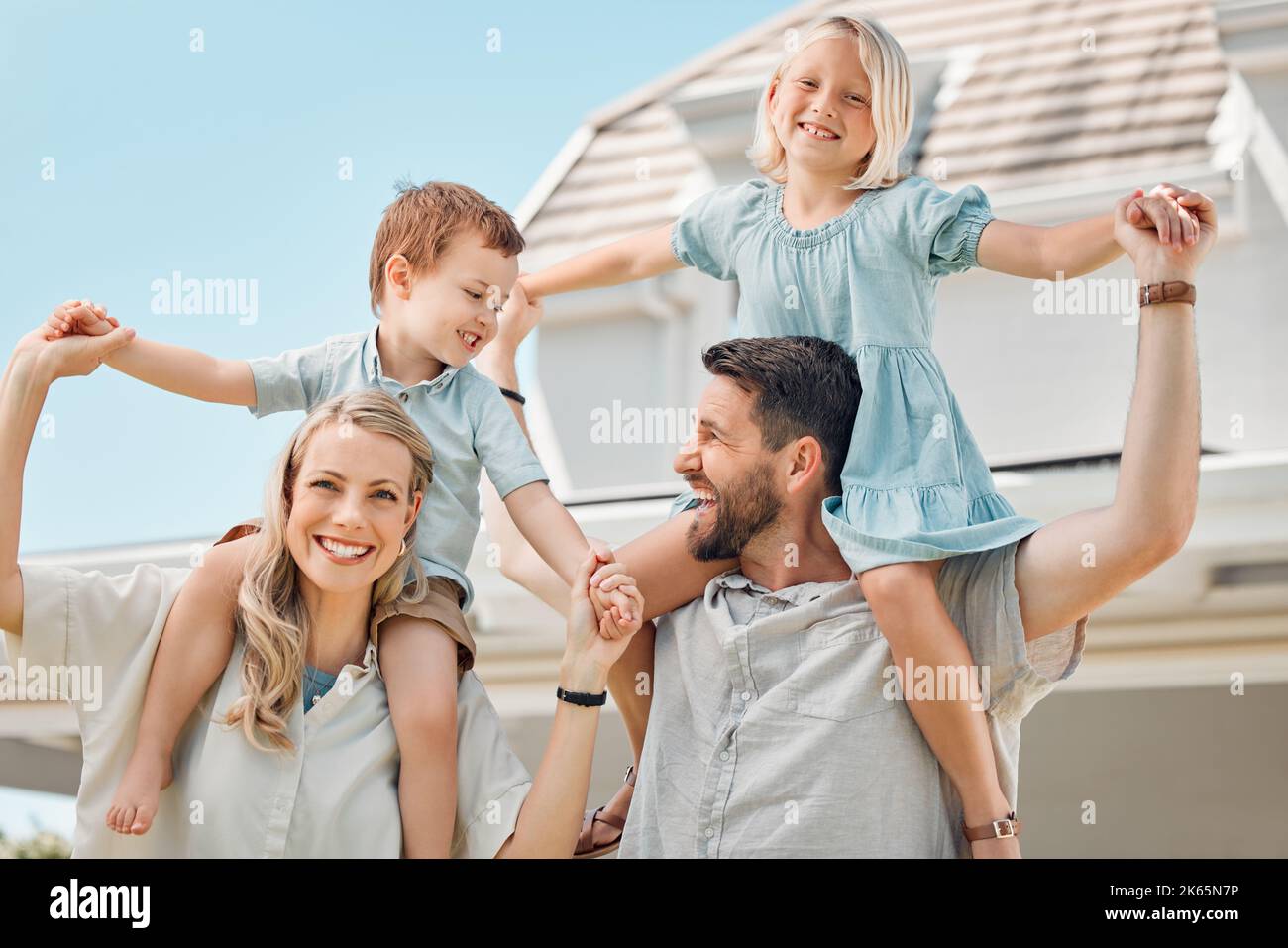 Parents giving kids piggyback rides. Family bonding outside in their ...