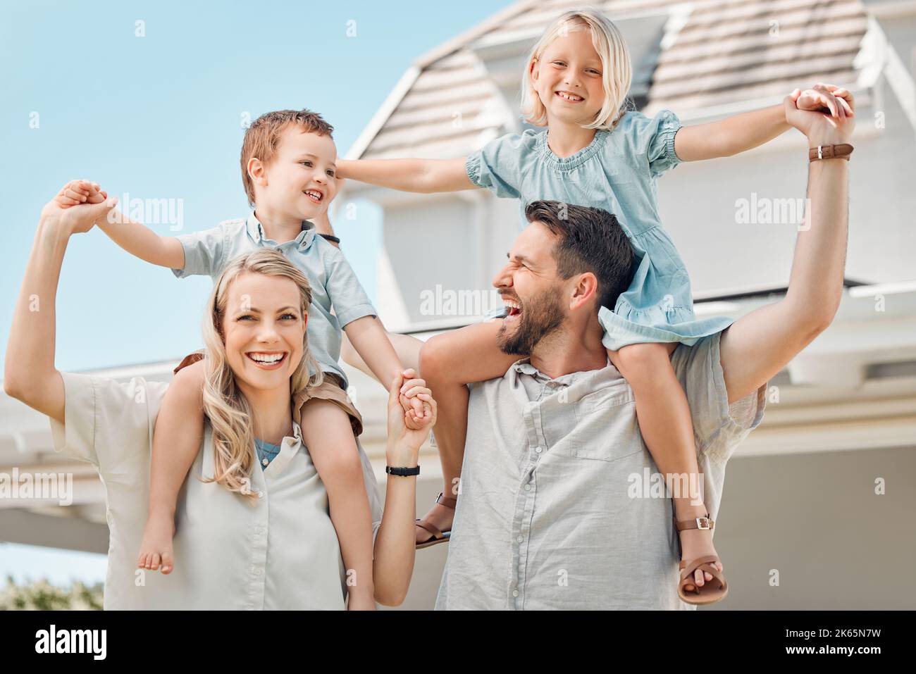 Parents giving kids piggyback rides. Family bonding outside in their ...